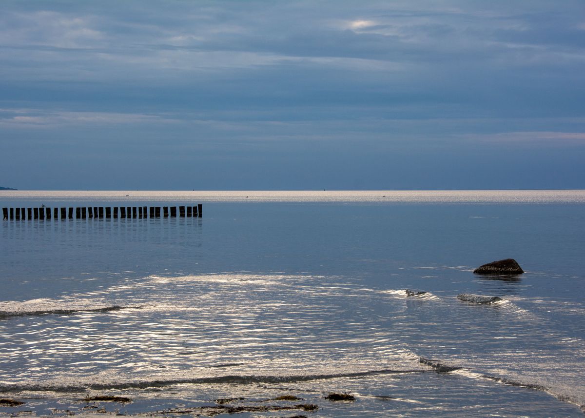 'Breakwater in the calm sea' Poster by Claudia Evans | Displate