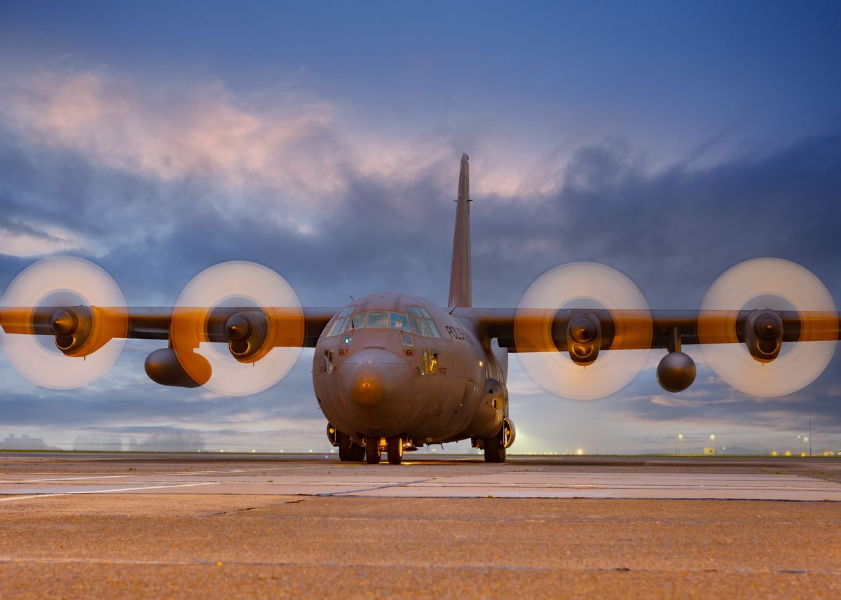 'C130 starting up at sunset' Poster by Simon Van Assche | Displate